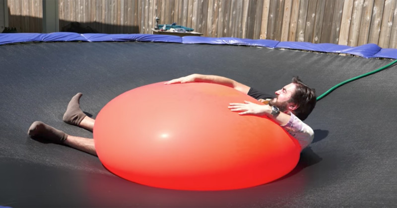 Man gets squashed (and soaked) by a 6-foot water balloon in glorious ...